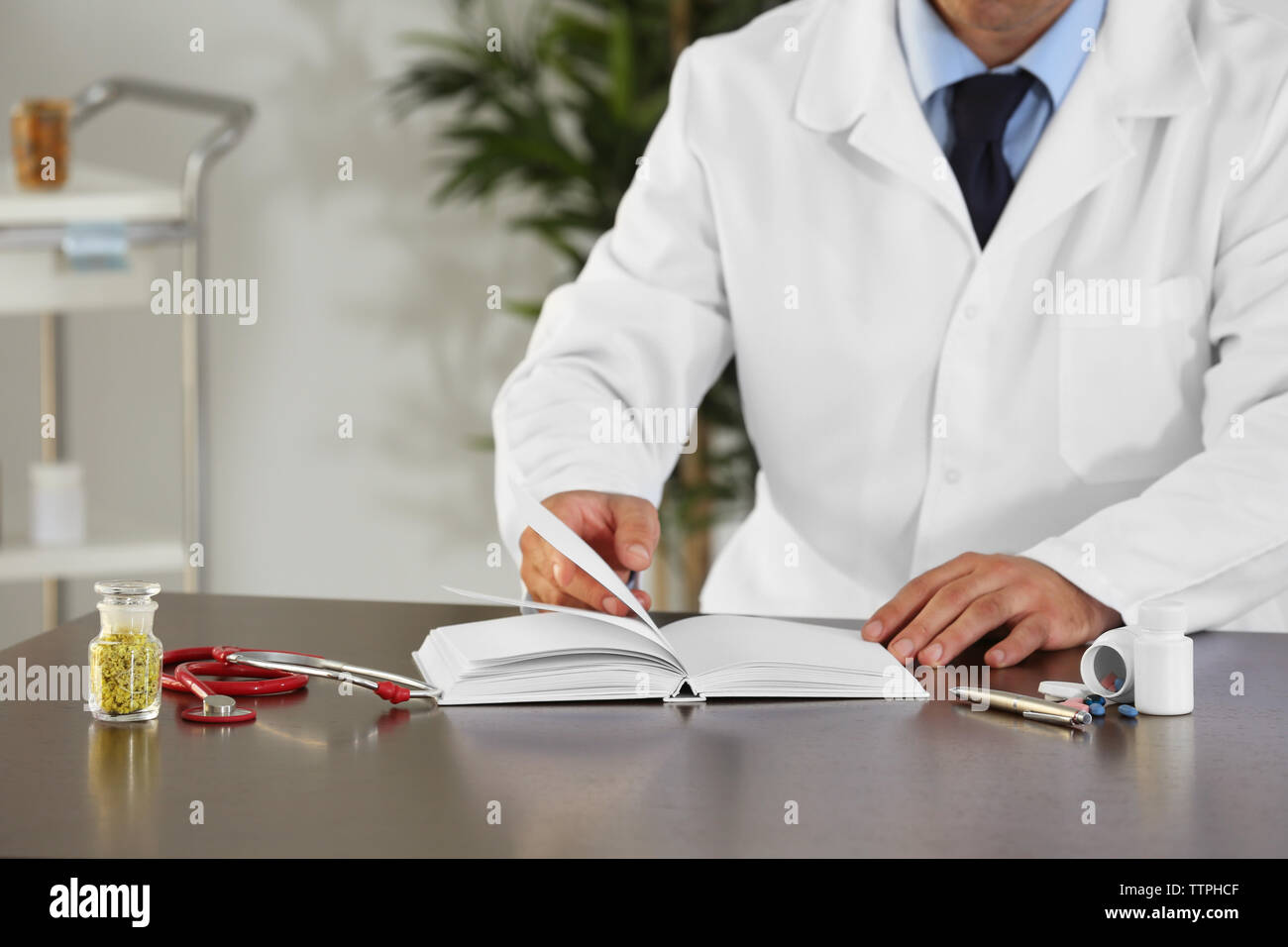 Male doctor with medical recipe book. Herbal medicine concept Stock ...