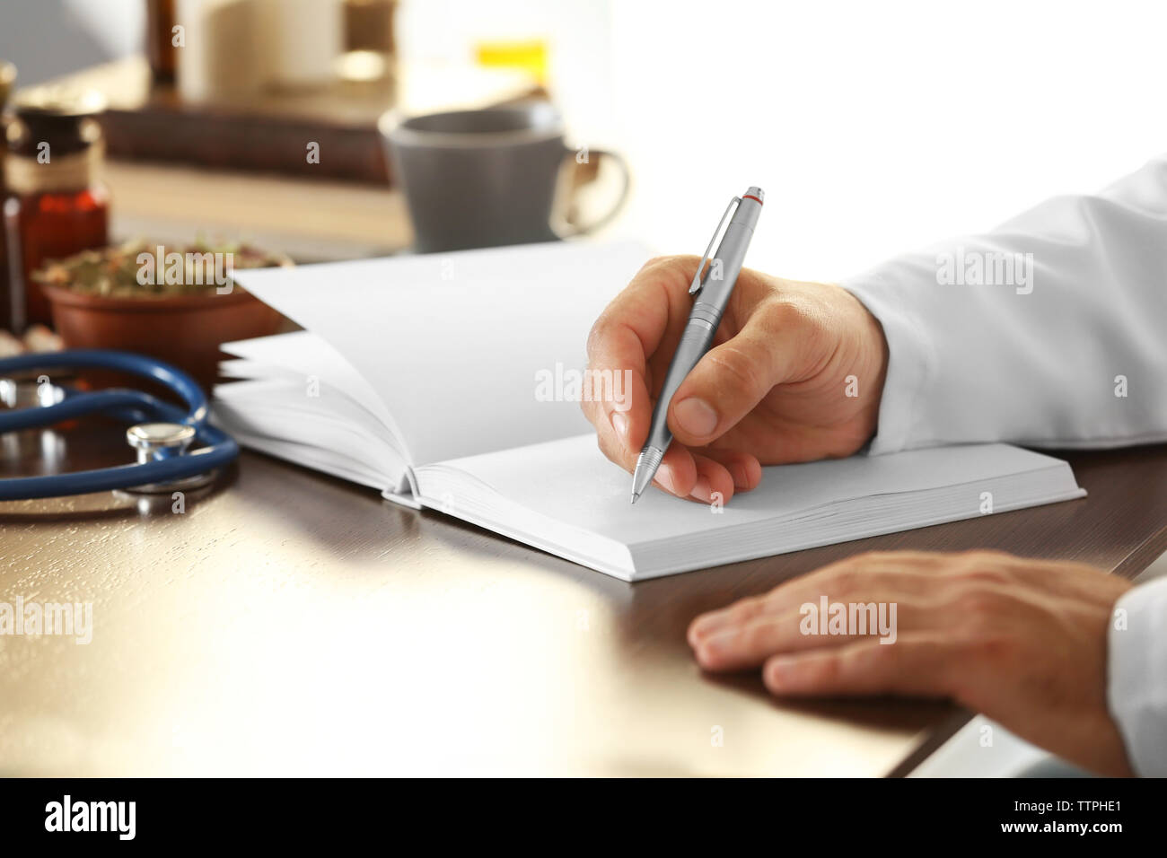 Male doctor with medical recipe book. Herbal medicine concept Stock ...