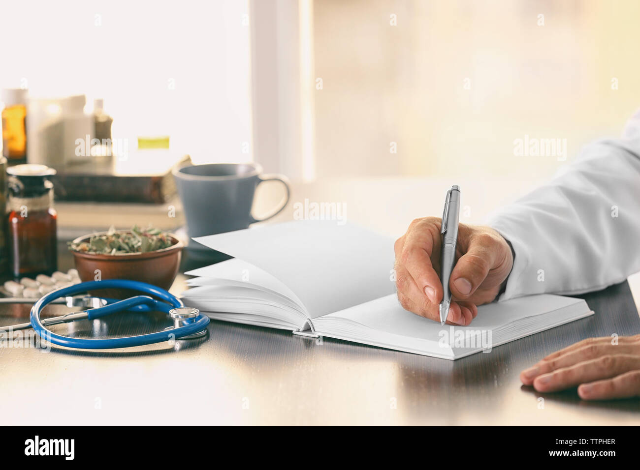 Male doctor with medical recipe book. Herbal medicine concept Stock ...