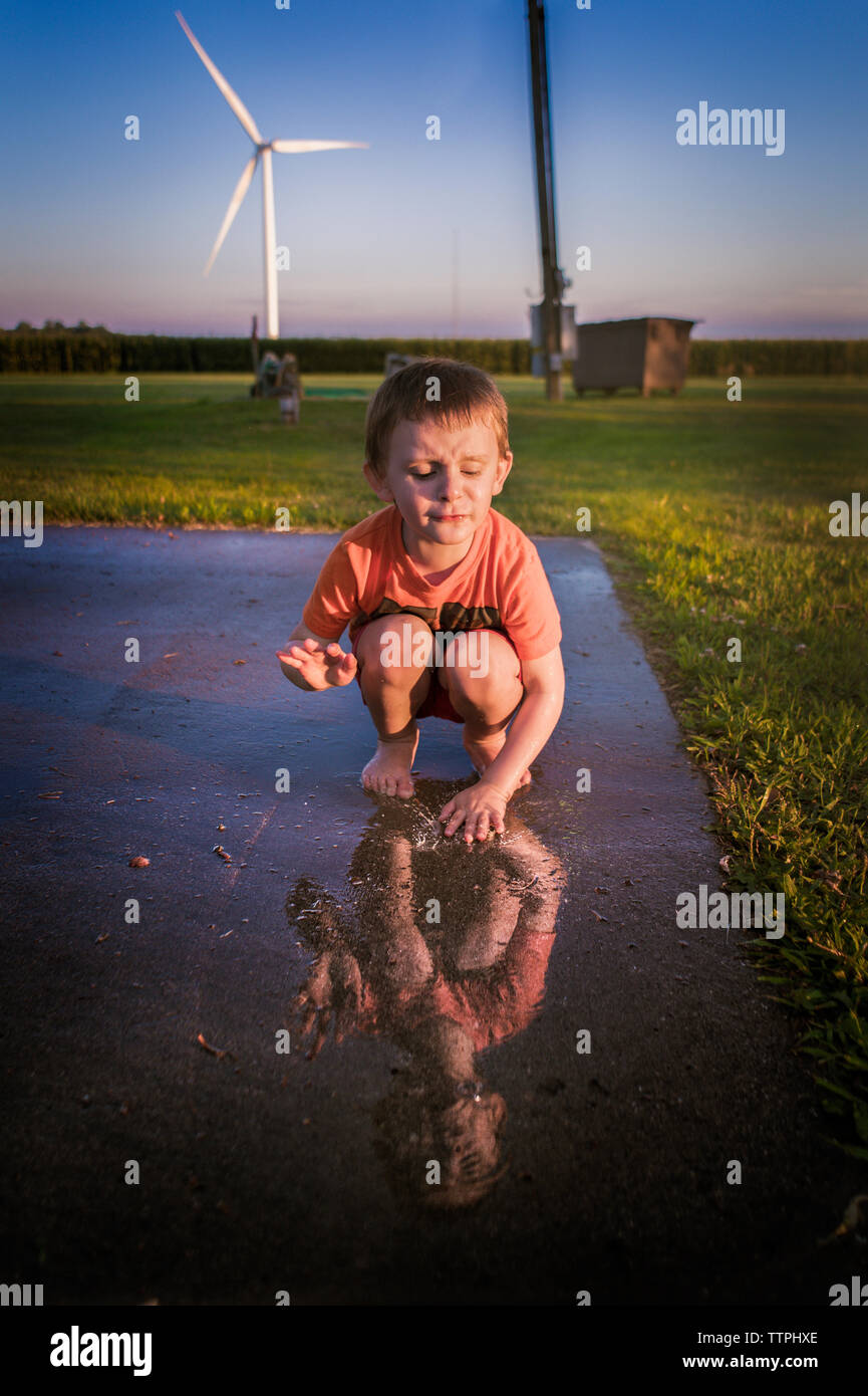 Kids playing in puddle hi-res stock photography and images - Alamy