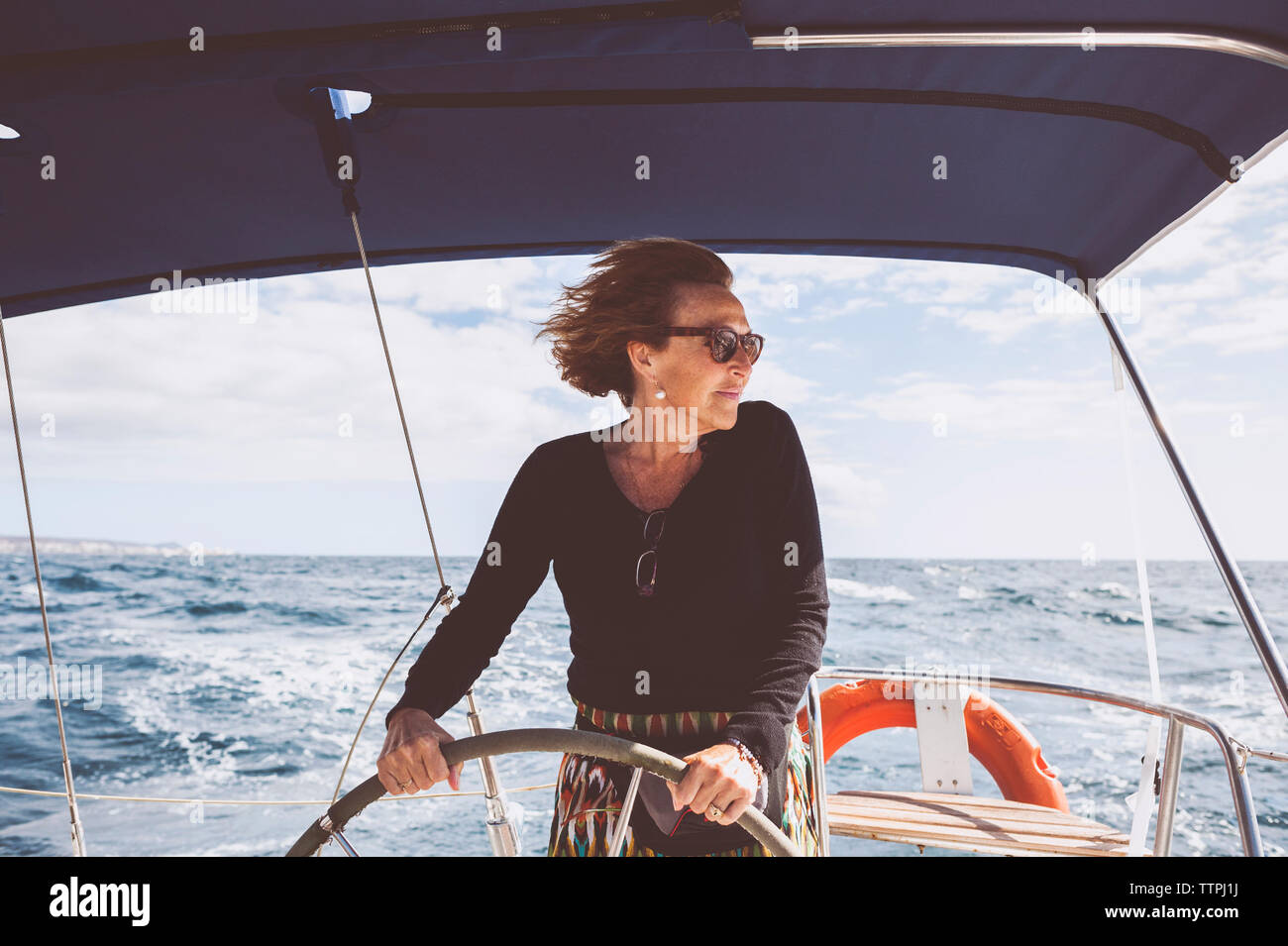Woman driving boat hi-res stock photography and images - Alamy