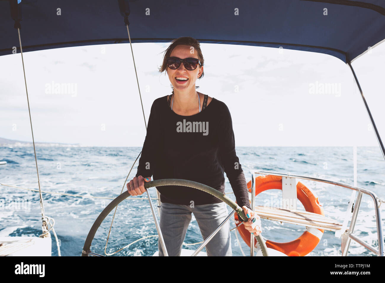 Woman steering boat hi-res stock photography and images - Alamy