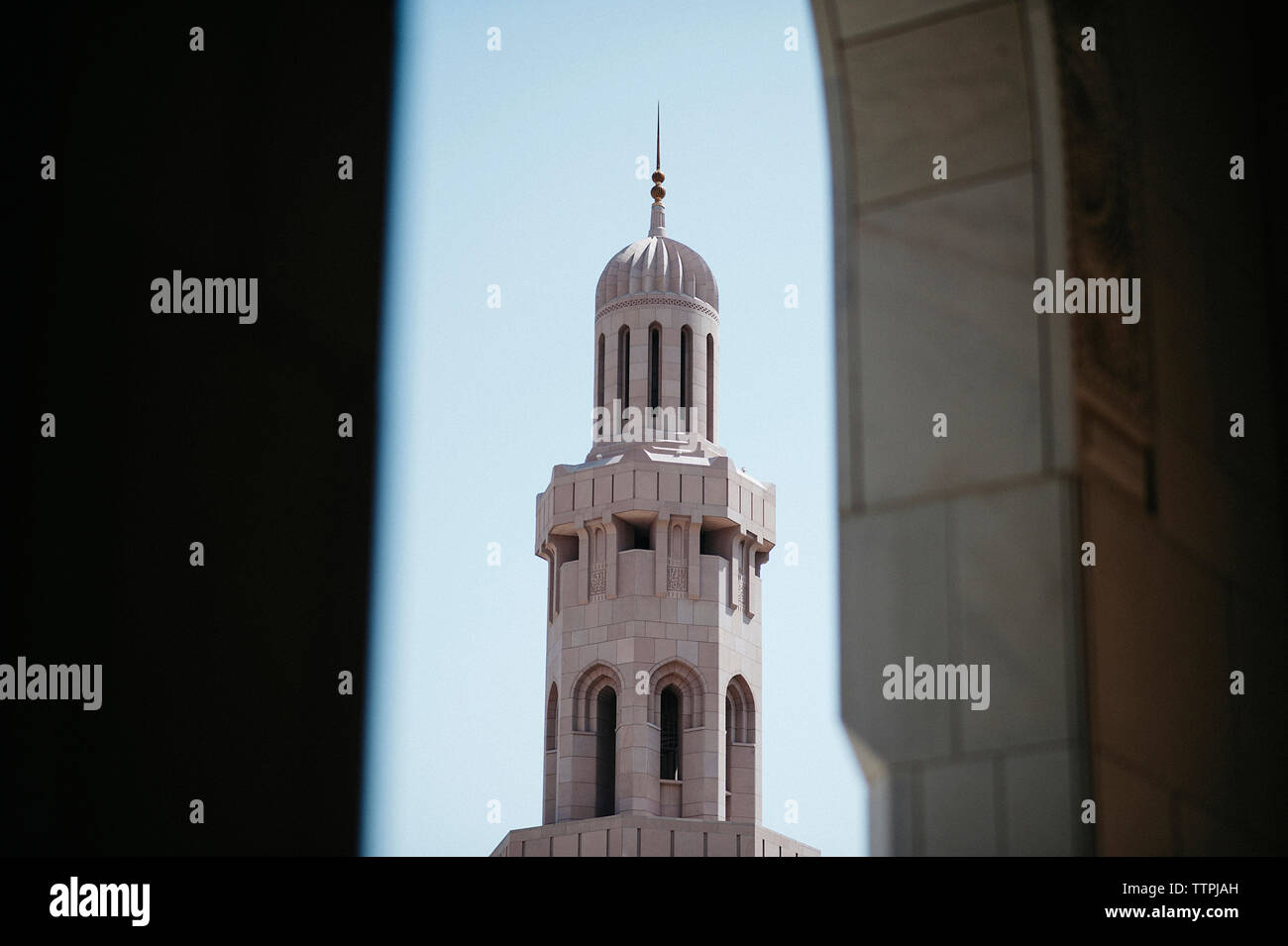 Minaret seen from arch window of Sultan Qaboos Grand Mosque Stock Photo ...
