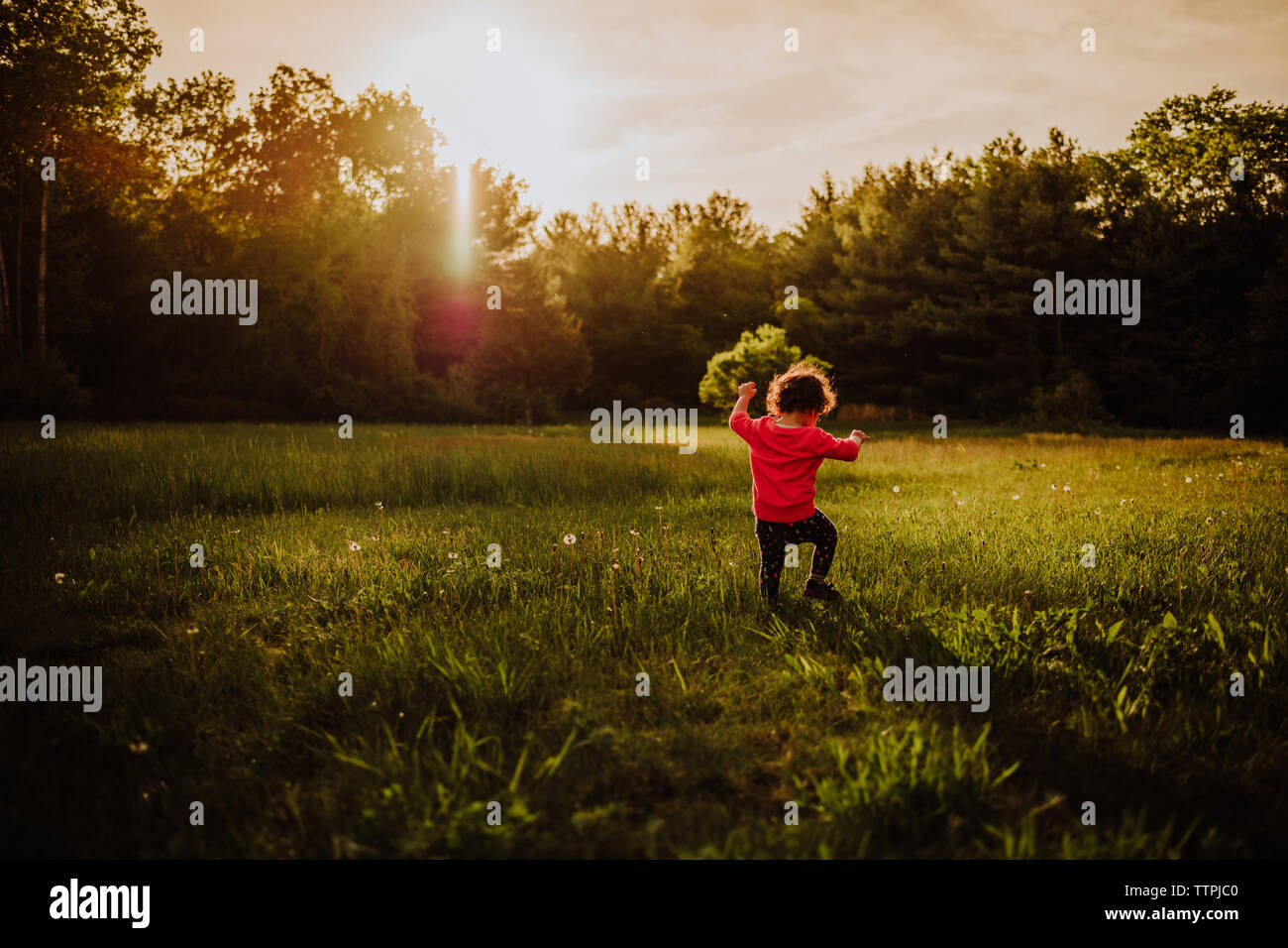 Little girl running outside Stock Photo - Alamy