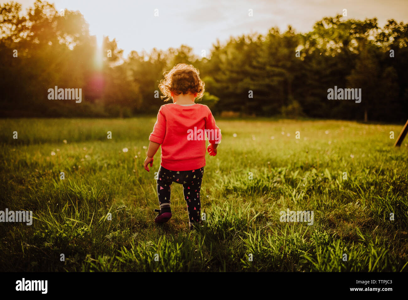 Little girl walking outside Stock Photo - Alamy