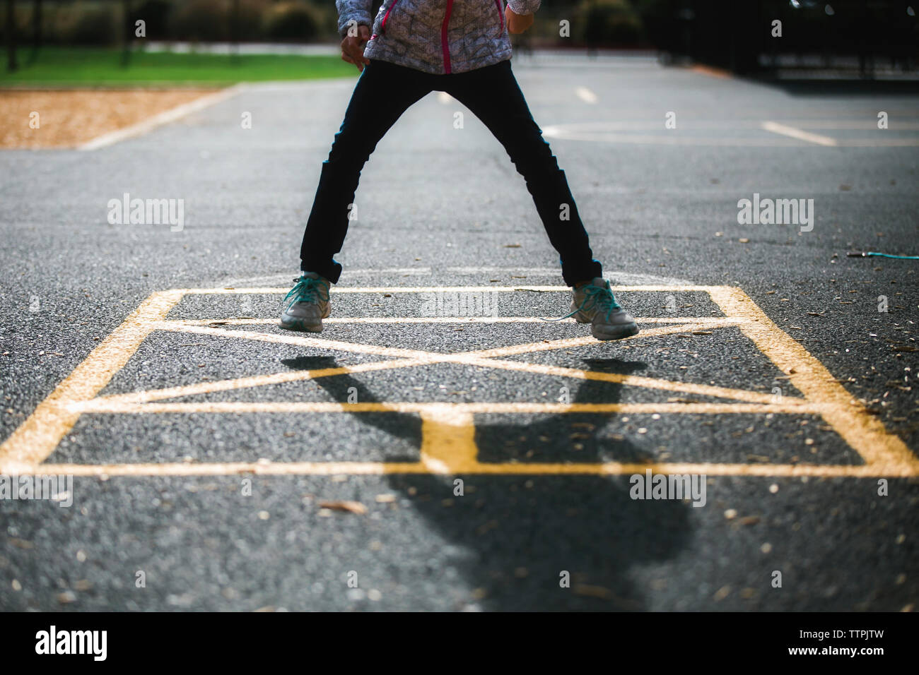 Low section view of girl playing on road Stock Photo - Alamy