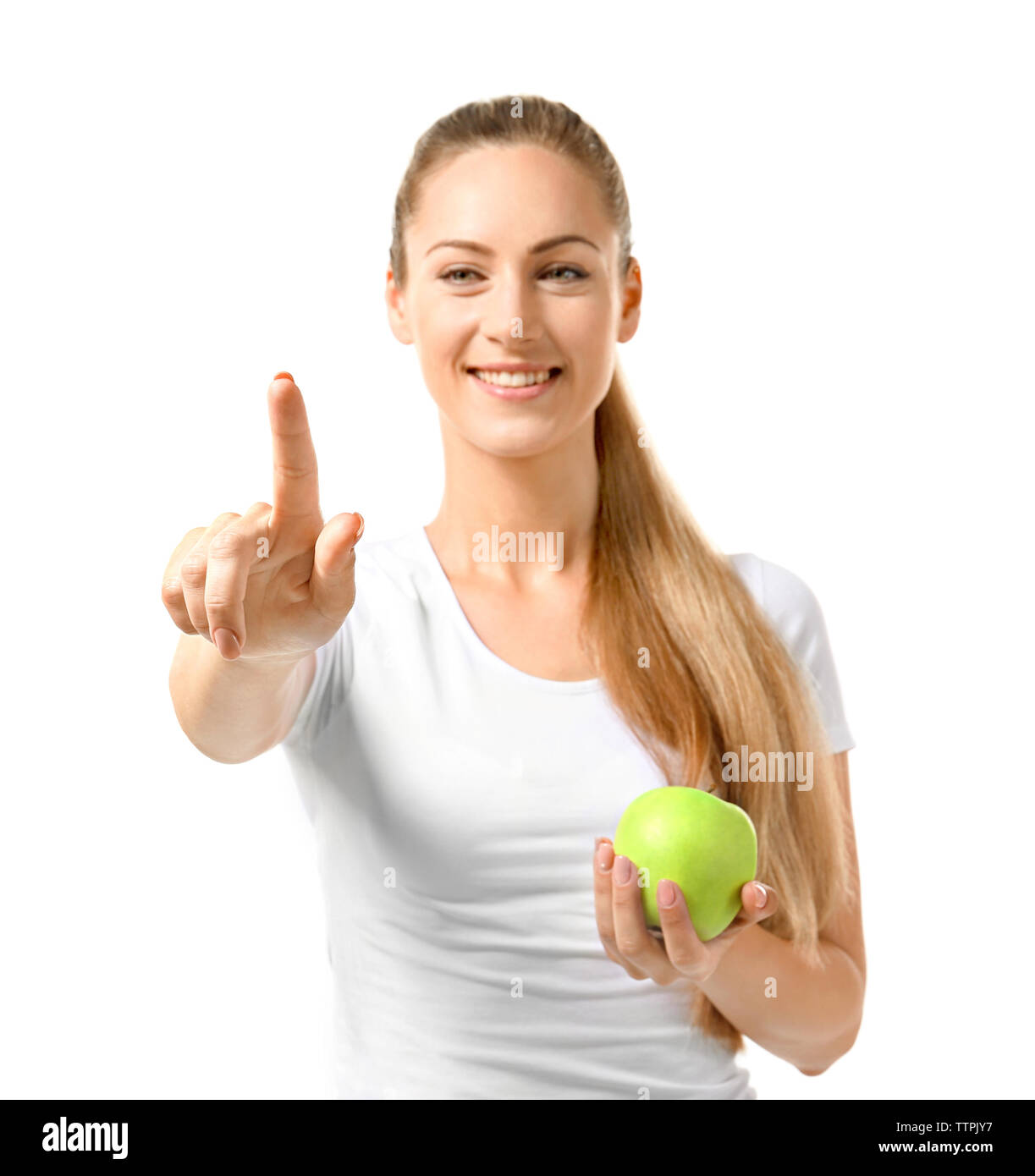 Beautiful girl with apple pointing finger, isolated on white Stock ...
