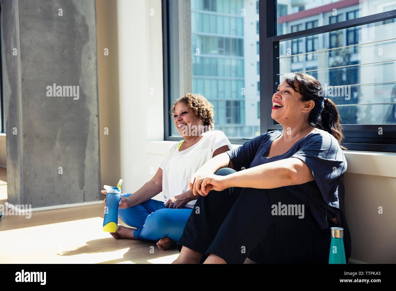 Happy female friends window hi-res stock photography and images - Alamy