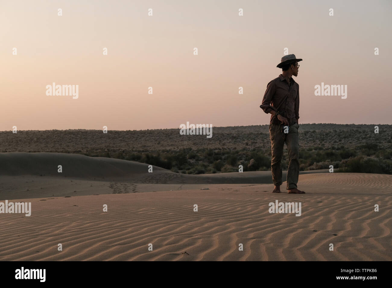 Man standing desert dune looking view hi-res stock photography and ...