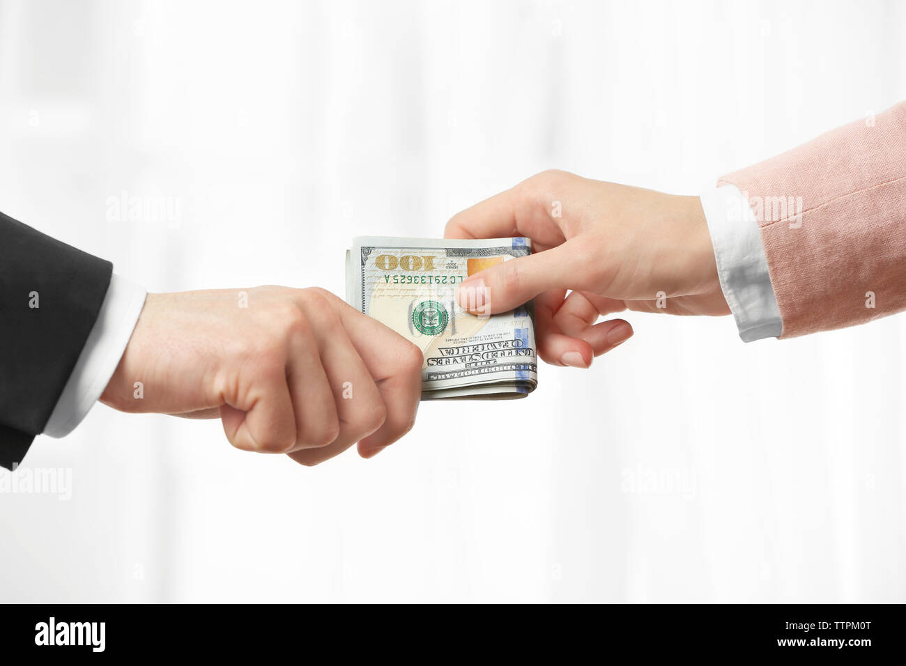 Man in suit taking bribe from woman hand closeup Stock Photo - Alamy