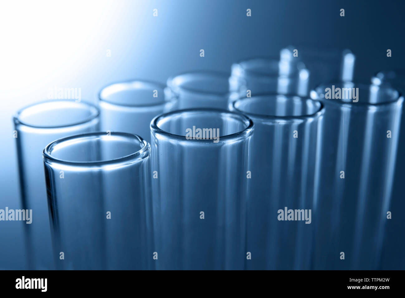 Test tubes on blue background Stock Photo - Alamy