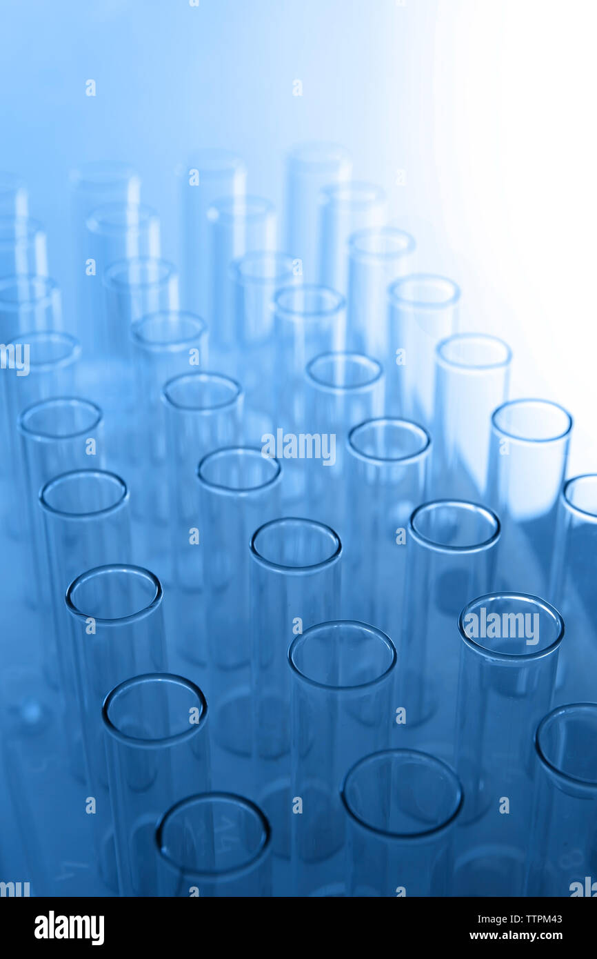 Test tubes on blue background Stock Photo - Alamy