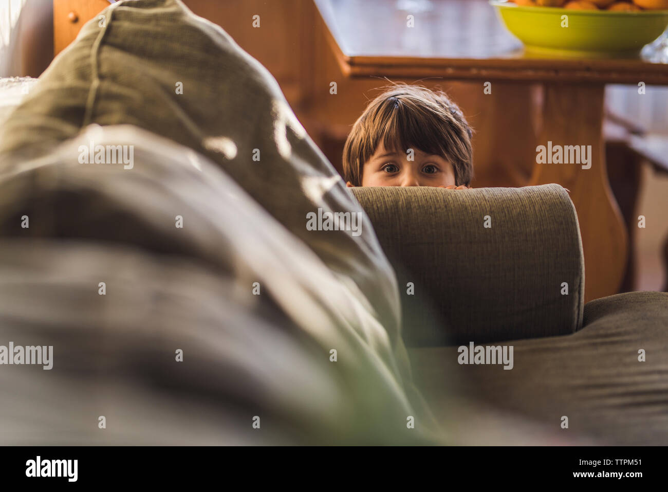 Hiding behind the sofa hi-res stock photography and images - Alamy