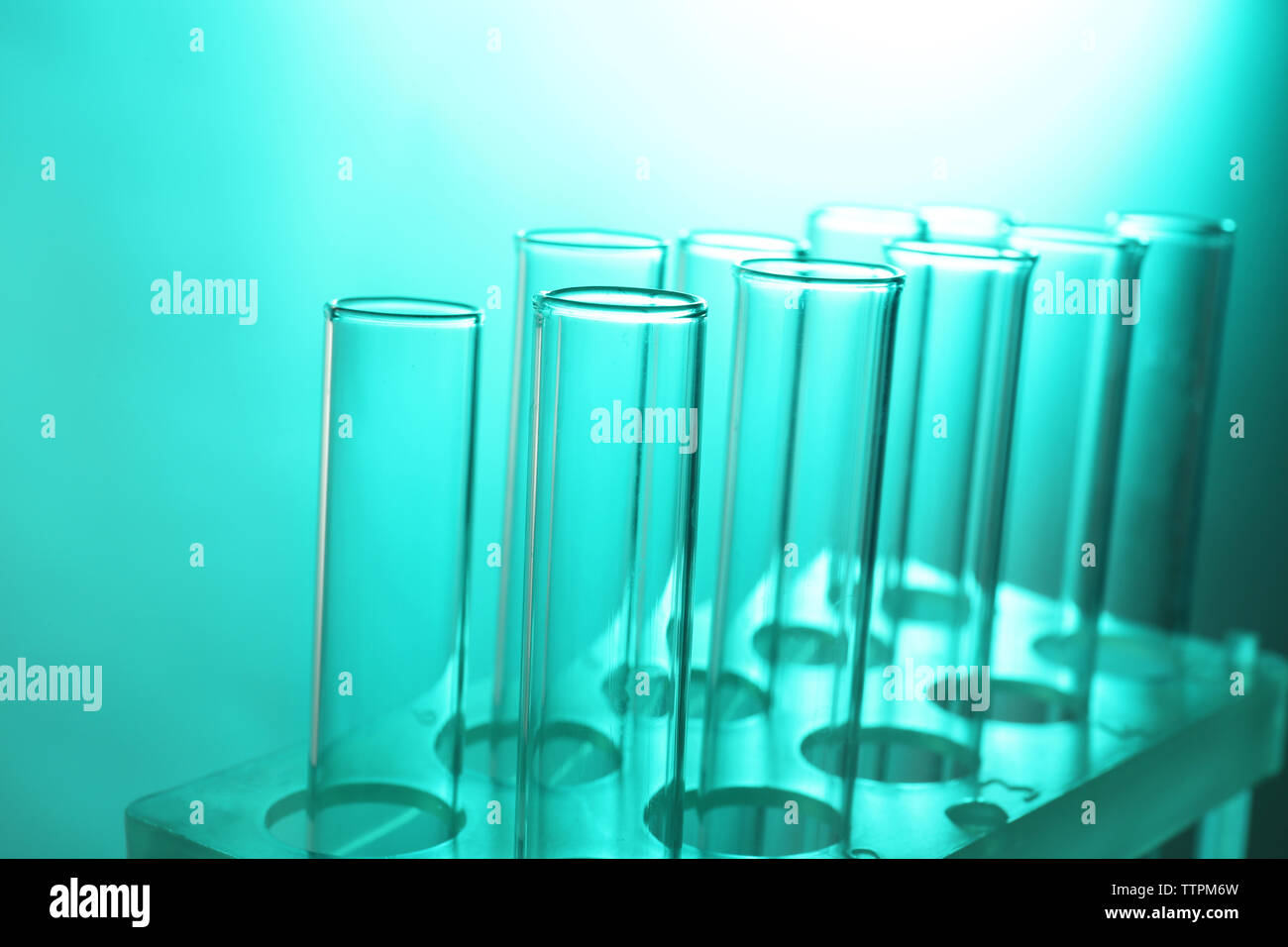 Test tubes on turquoise background Stock Photo - Alamy