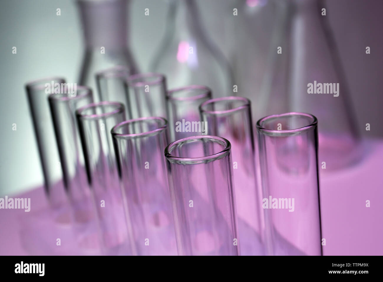 Test tubes on violet background Stock Photo - Alamy