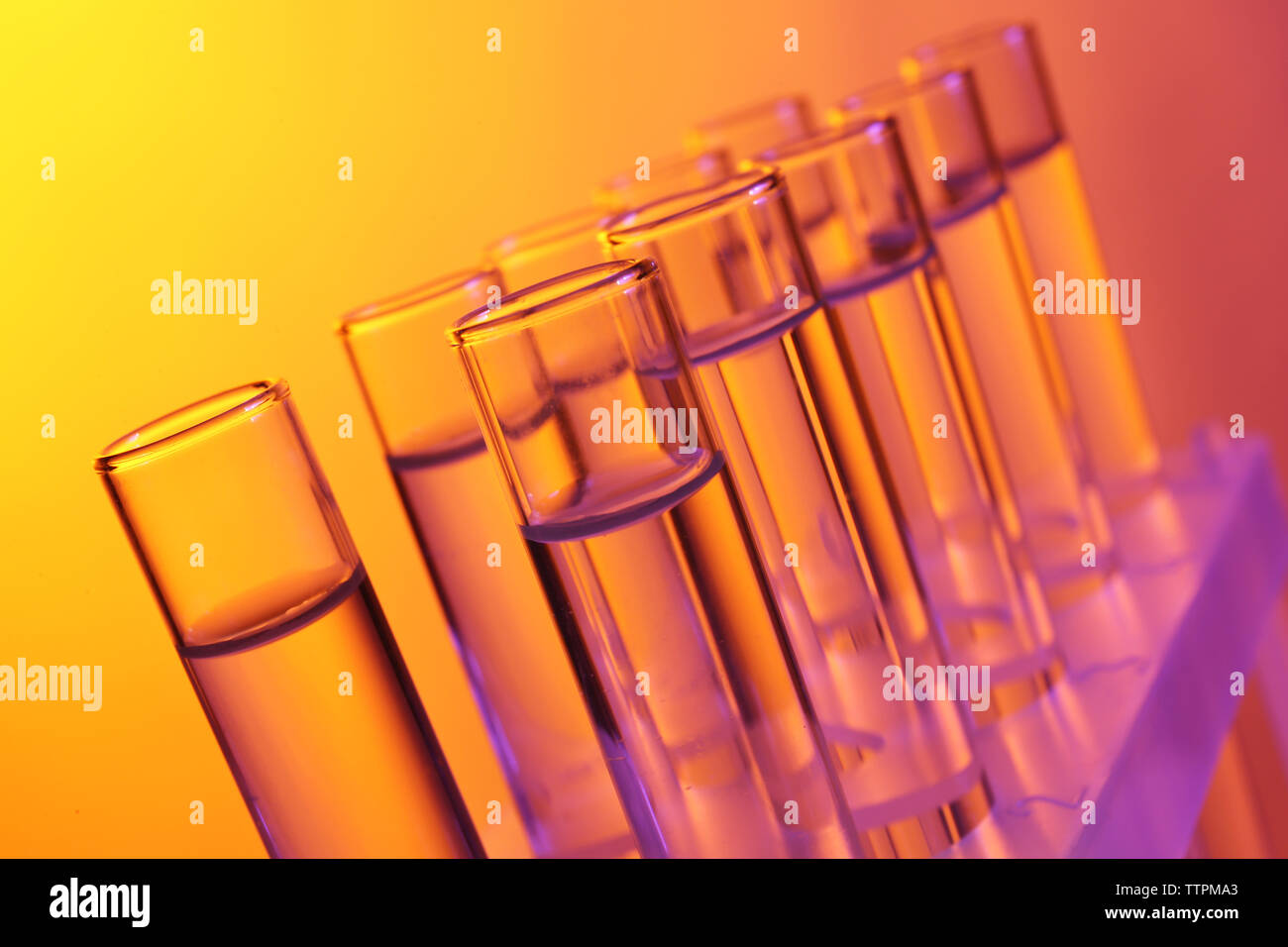 Test tubes on colourful background Stock Photo - Alamy