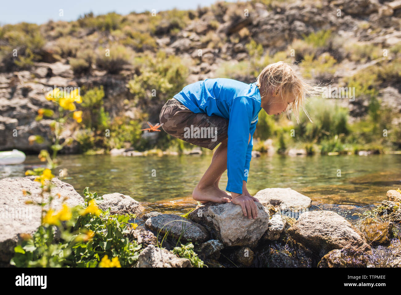 Boy playing on the rocks hi-res stock photography and images - Alamy