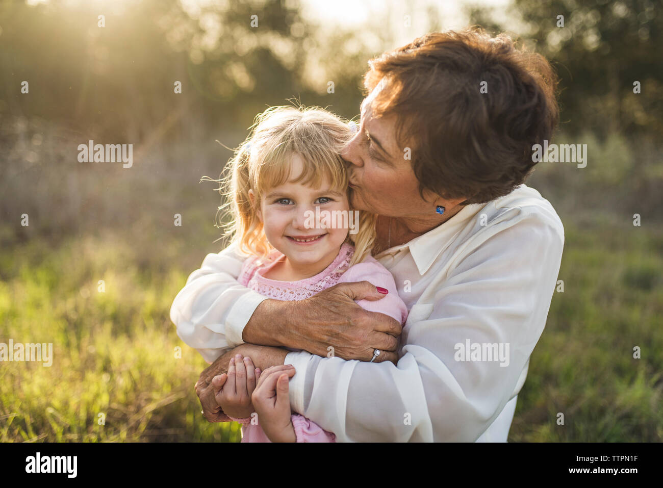 Smiling granddaughter hugging grandma hi-res stock photography and ...
