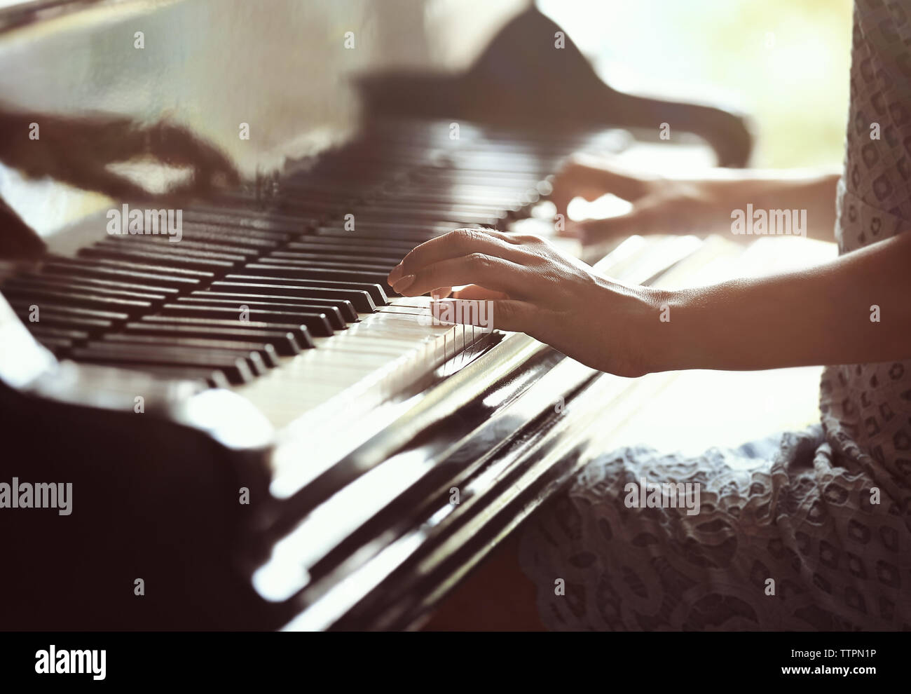 Beautiful woman playing piano Stock Photo - Alamy