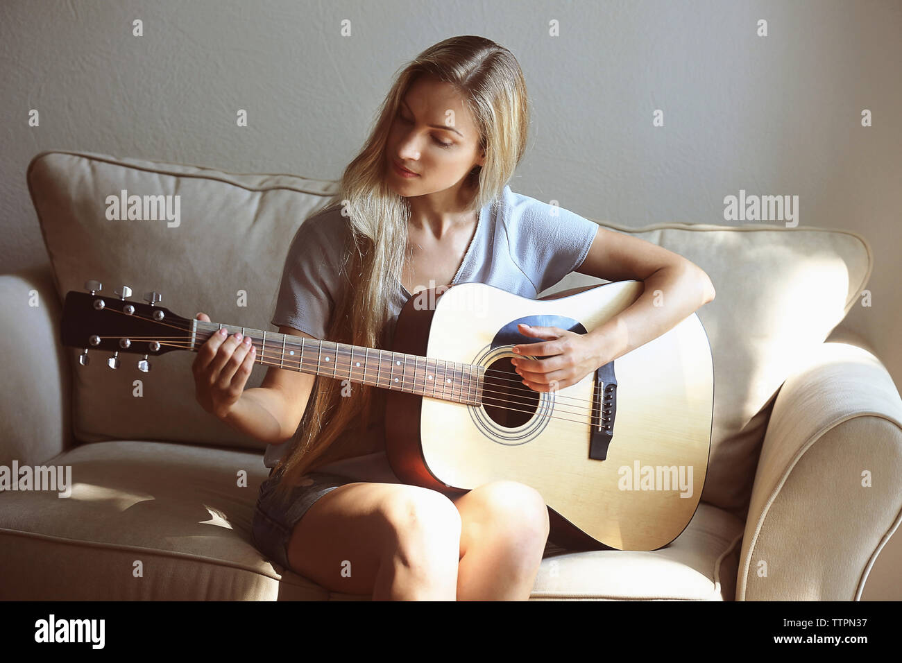 Beautiful woman playing guitar Stock Photo - Alamy