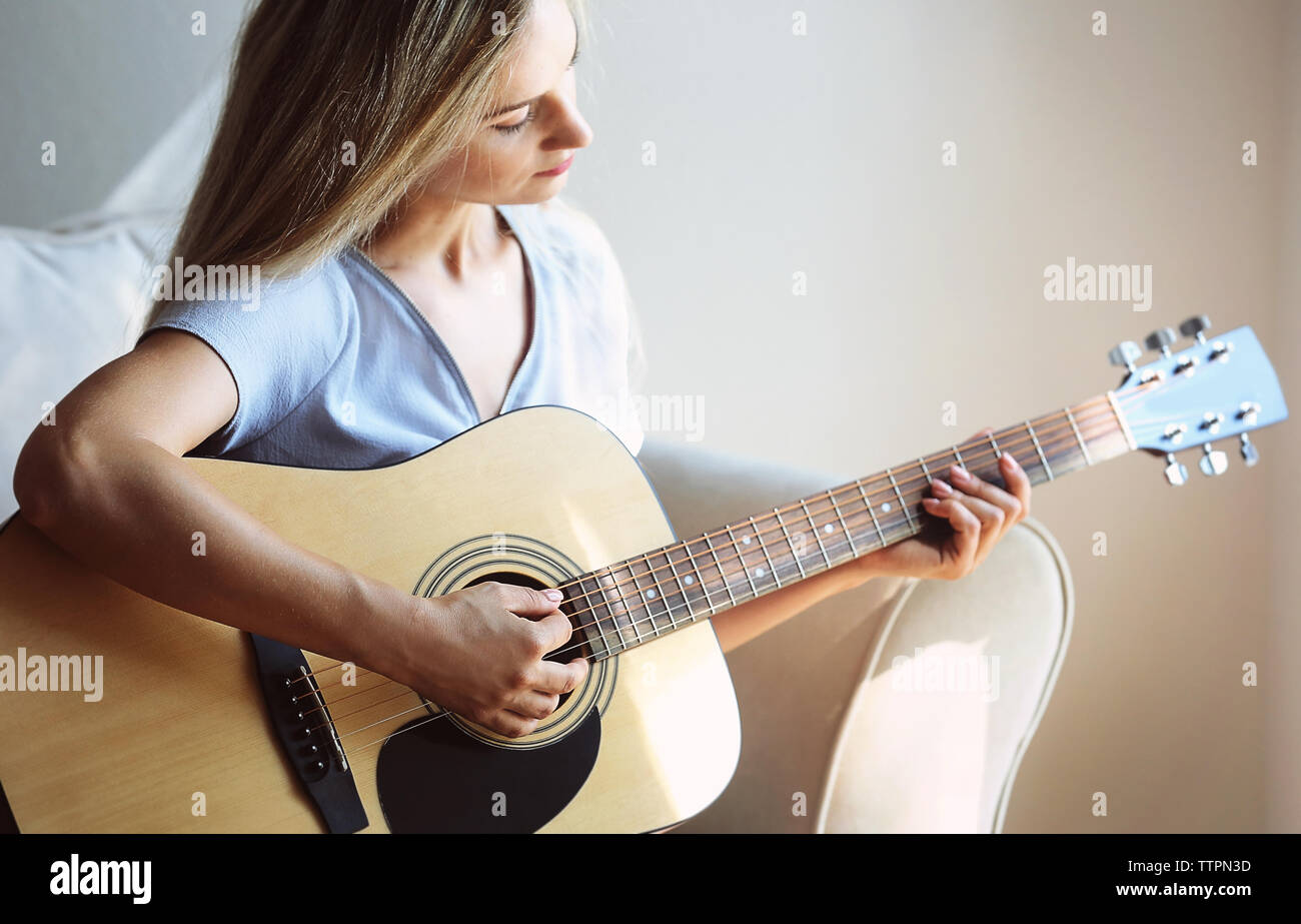 Beautiful woman playing guitar Stock Photo - Alamy