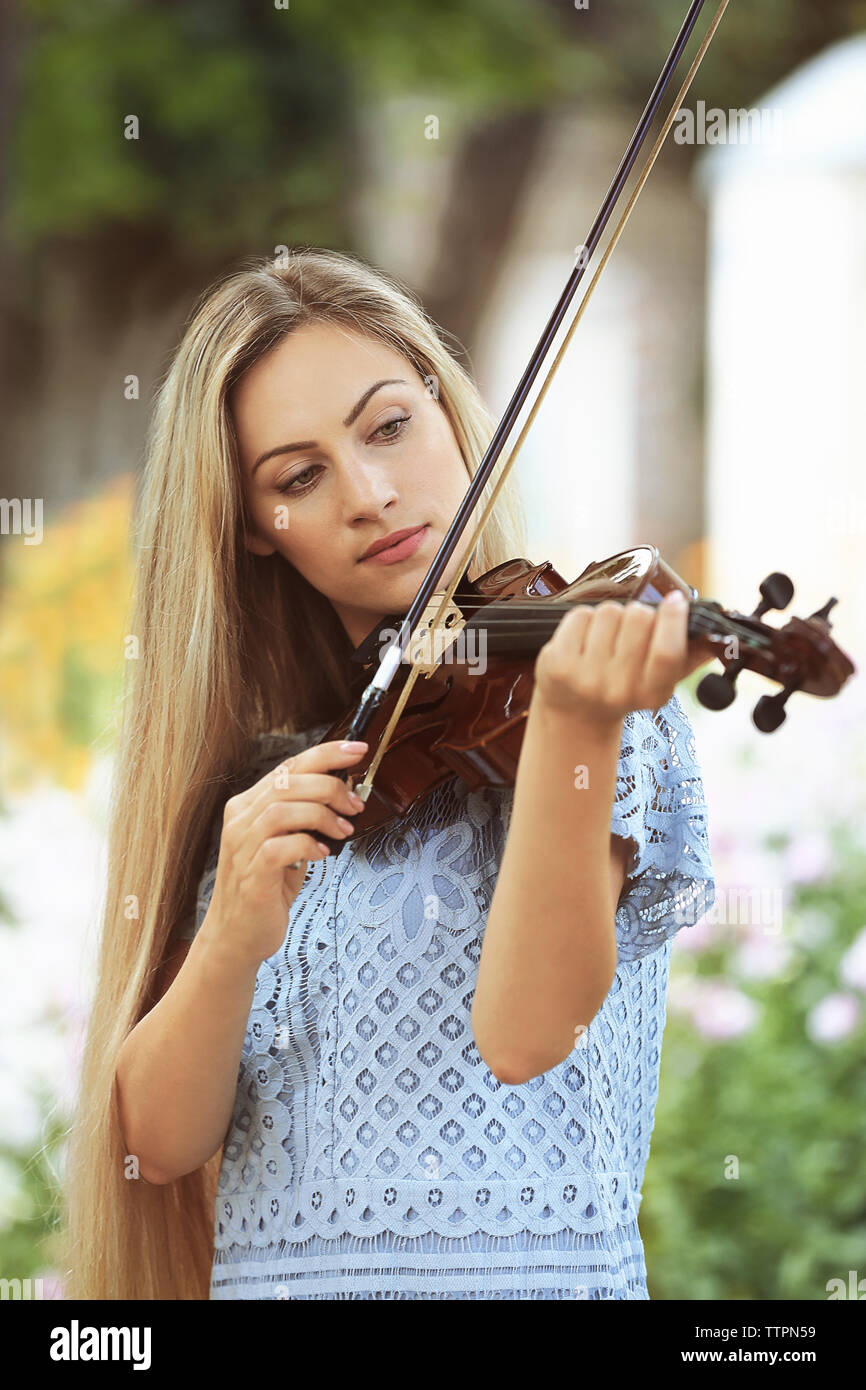 Beautiful woman playing violin Stock Photo - Alamy