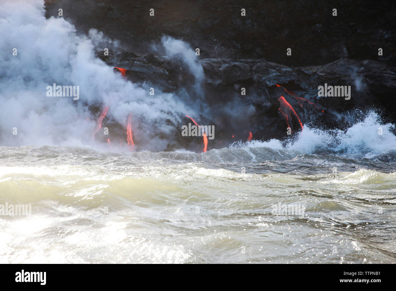 Steam emitting from lava rocks by sea Stock Photo - Alamy