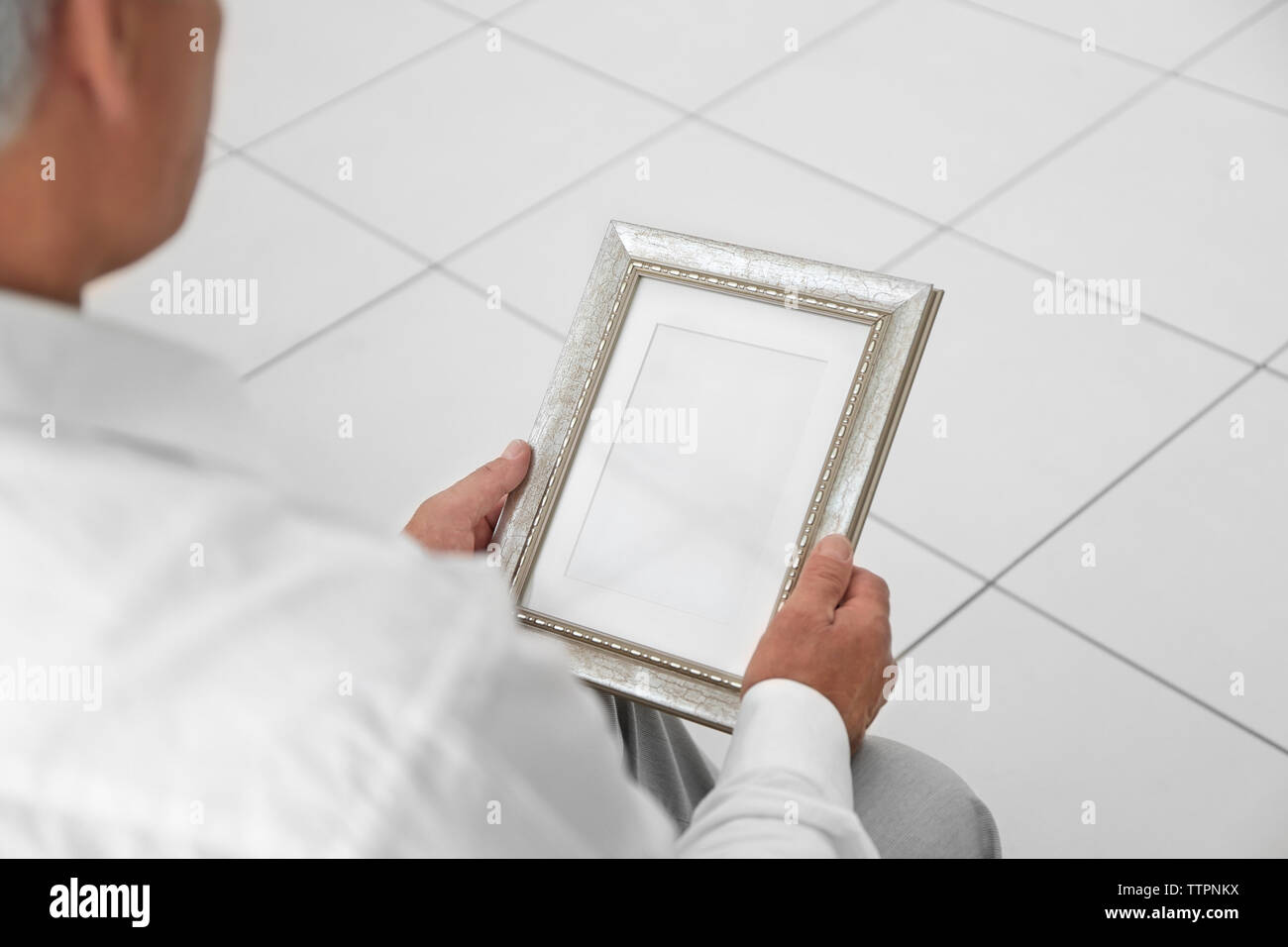 Man holding photo frame. Memories and nostalgia concept Stock Photo - Alamy
