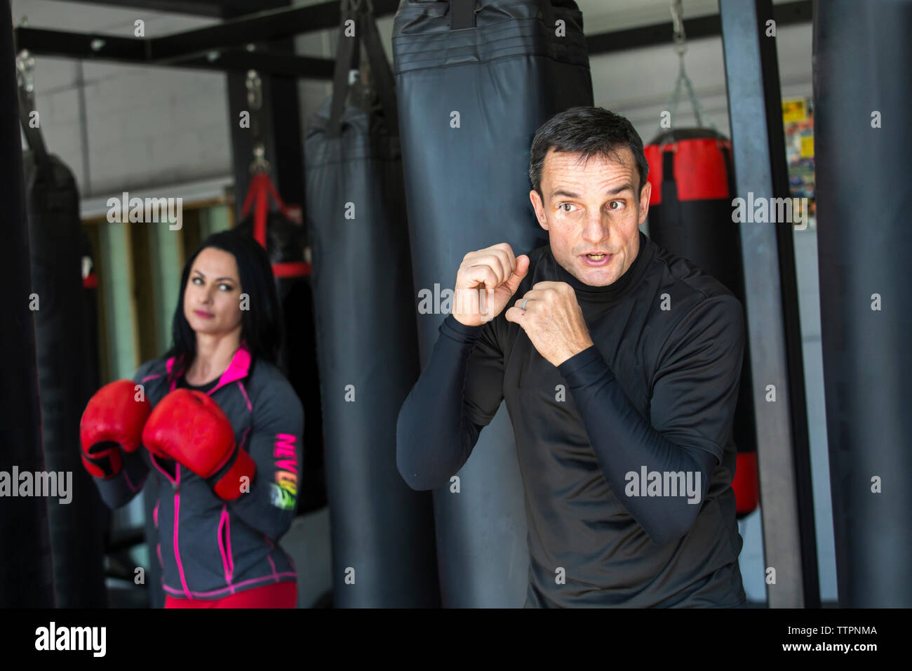 Coach training female boxer in gym Stock Photo - Alamy