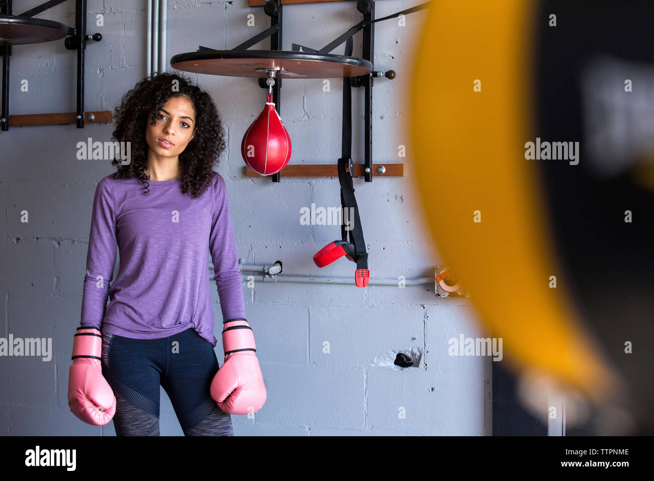 Portrait of female boxer standing by wall in gym Stock Photo - Alamy