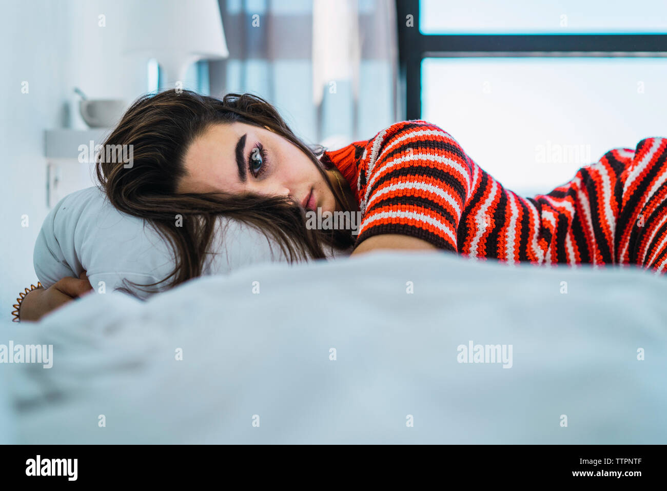 Woman lying bed window hi-res stock photography and images - Alamy
