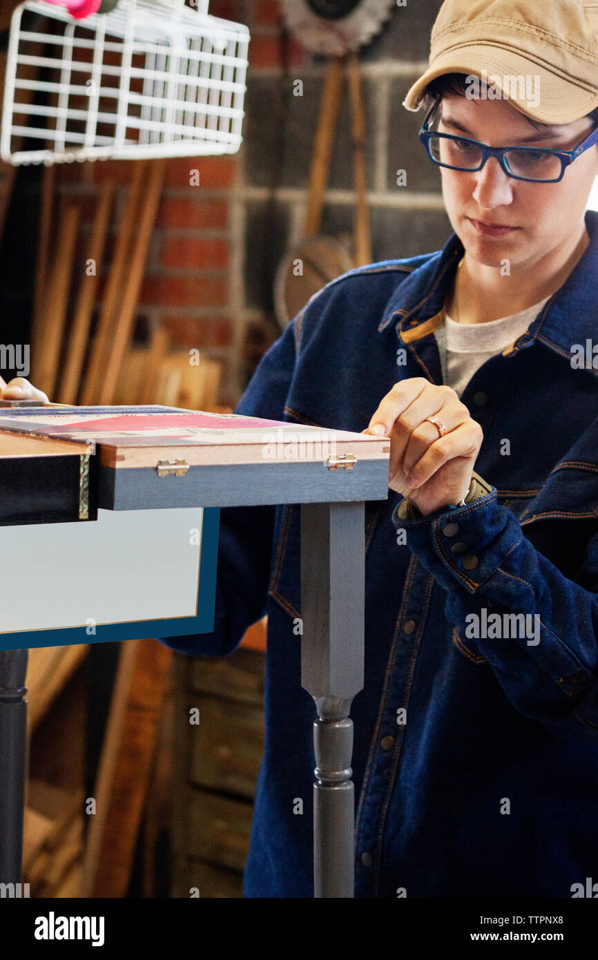 Female worker checking wood in workshop Stock Photo - Alamy