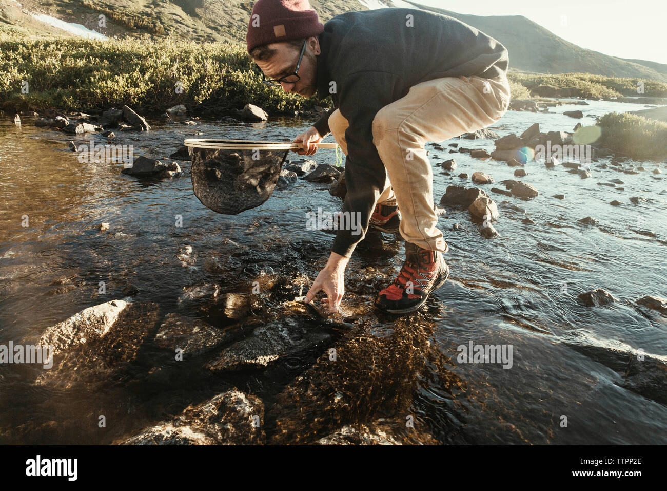 Man catching fish hi-res stock photography and images - Alamy