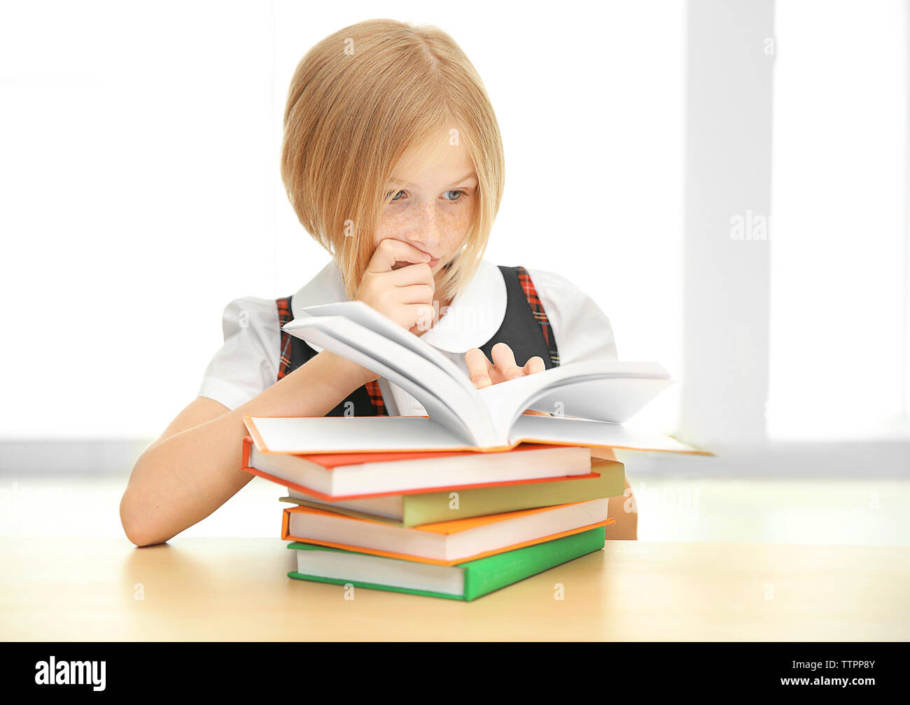 Girl with many books at school Stock Photo - Alamy