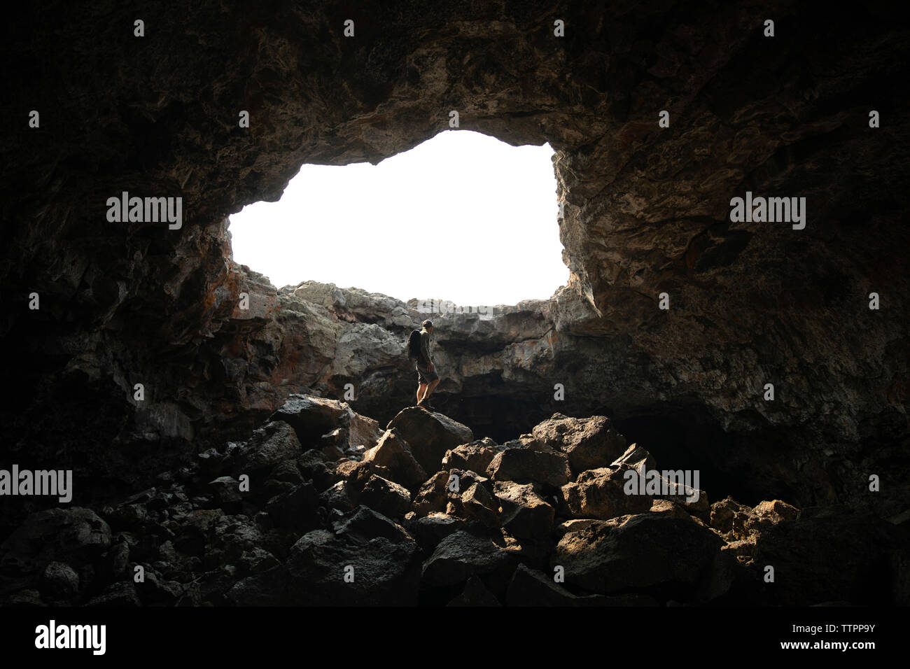 Young man standing cave hi-res stock photography and images - Alamy