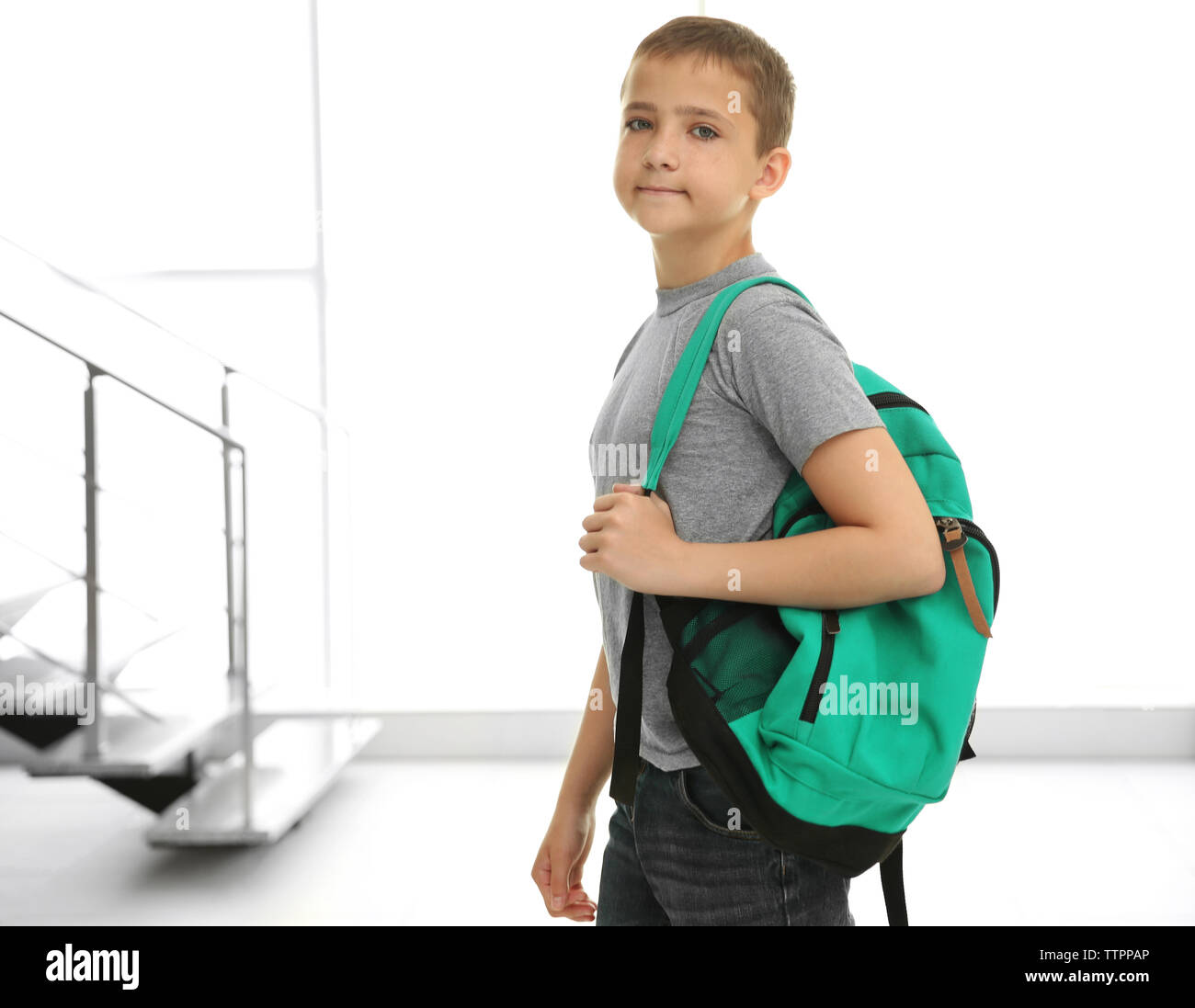 Cute schoolboy on light background Stock Photo - Alamy