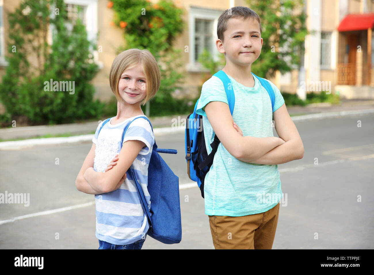 Cute schoolkids on street Stock Photo - Alamy