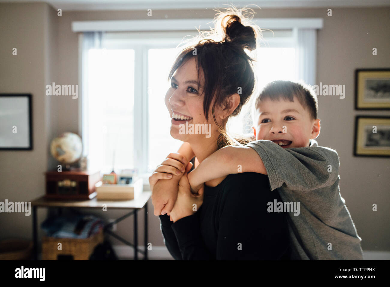 Mother piggybacking cheerful boy hi-res stock photography and images ...