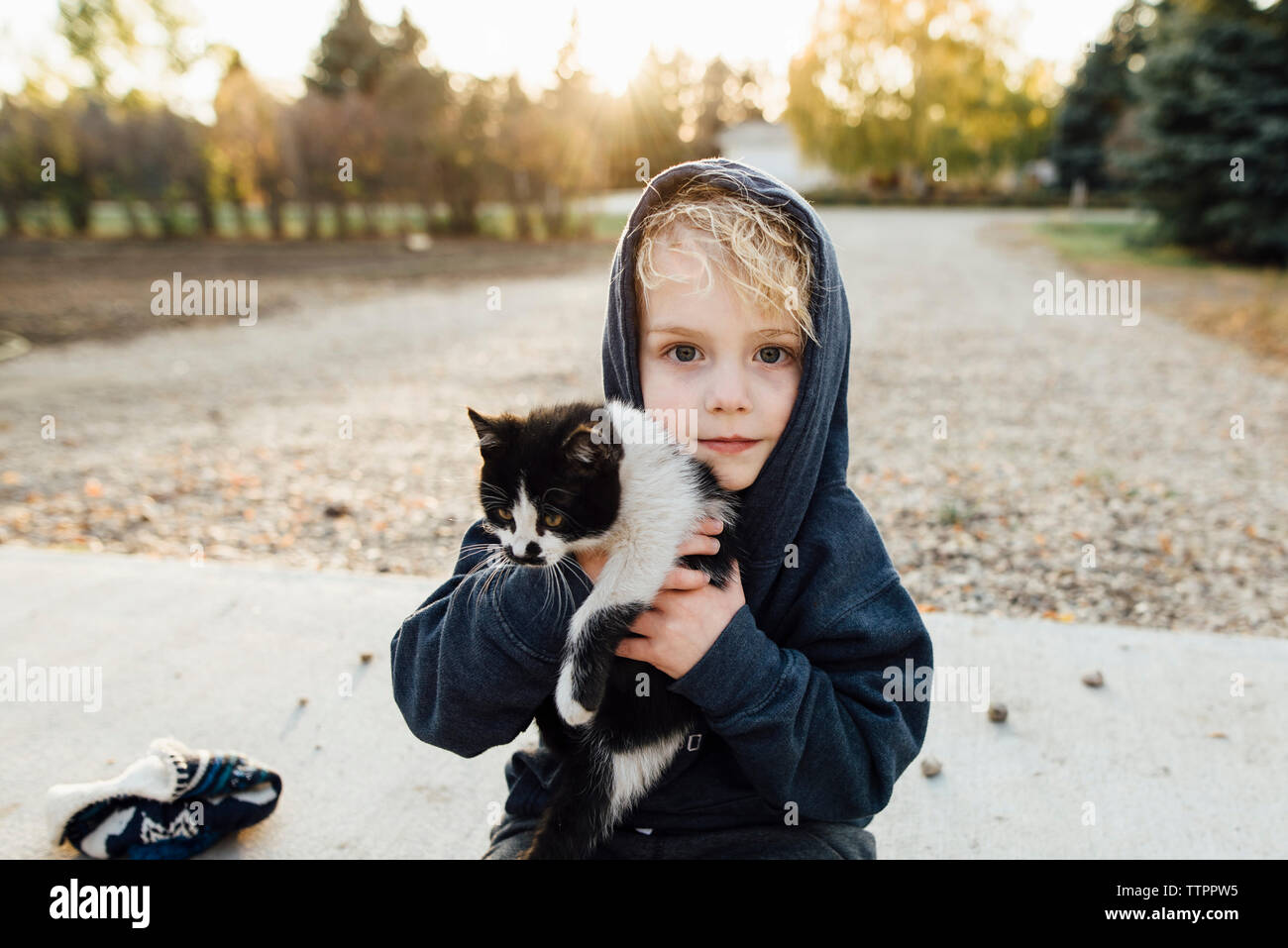 Boy carrying cat hi-res stock photography and images - Alamy