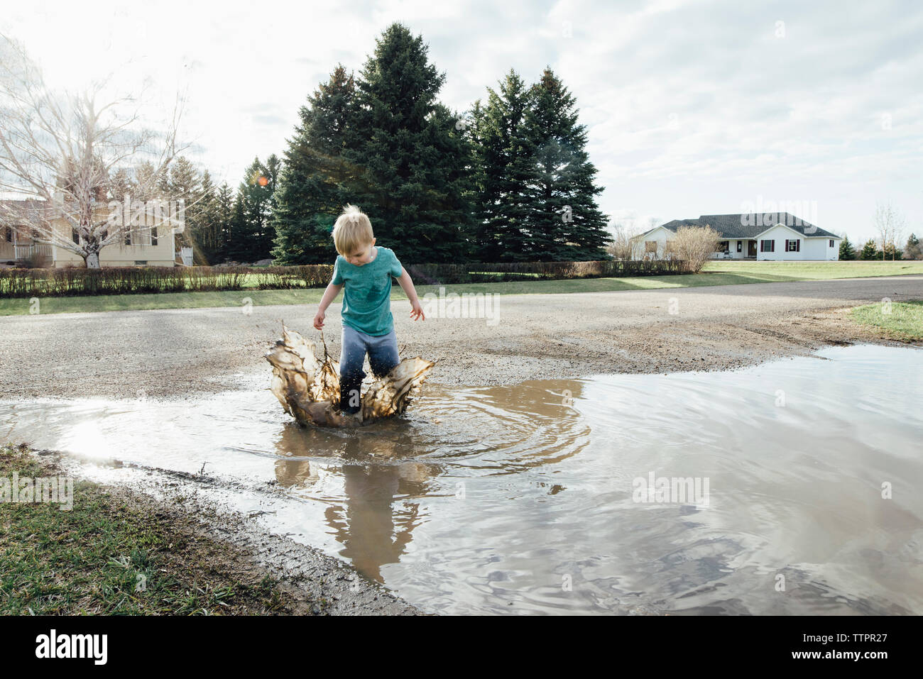 Boy Jumping In Puddle High Resolution Stock Photography and Images - Alamy
