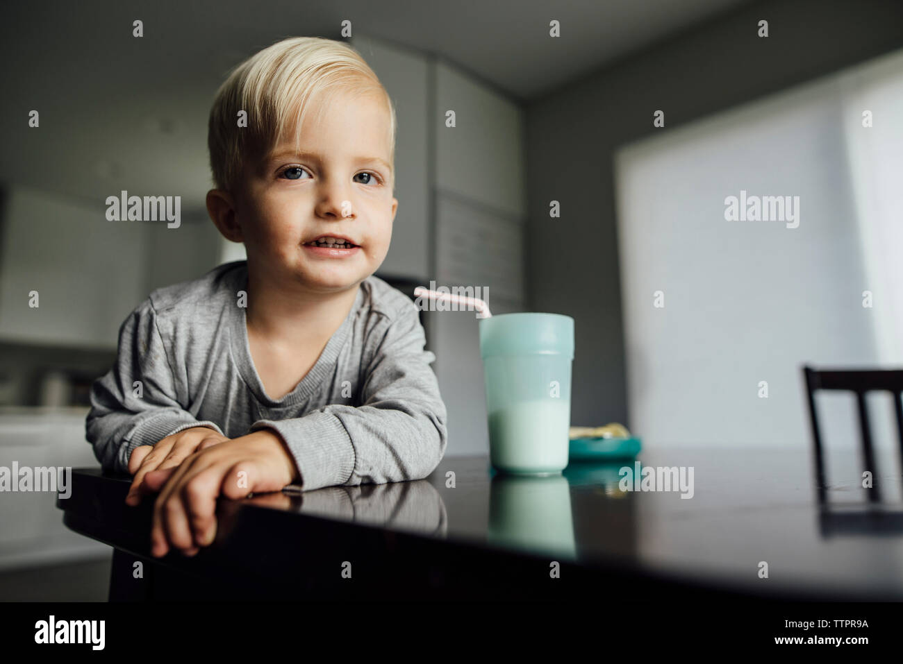 Portrait of cute boy at table Stock Photo - Alamy
