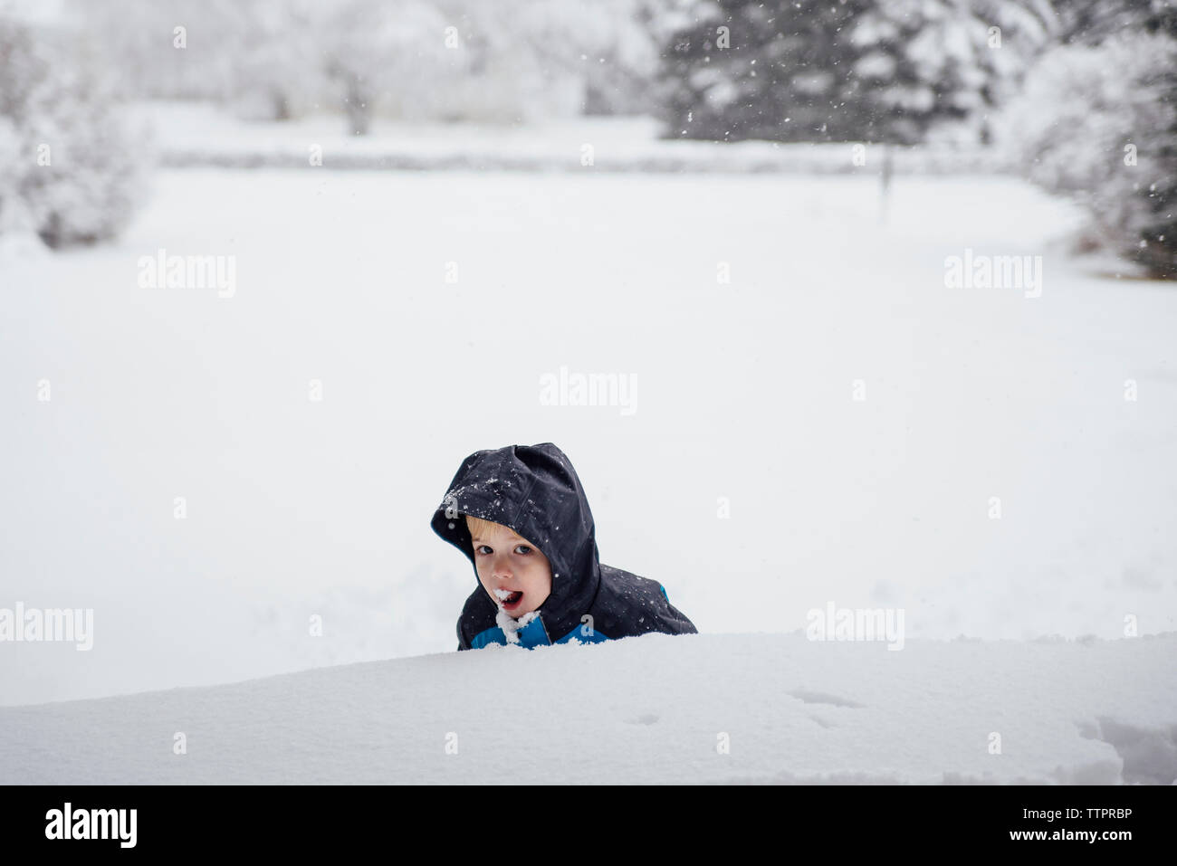 Boy standing on the snow hi-res stock photography and images - Alamy