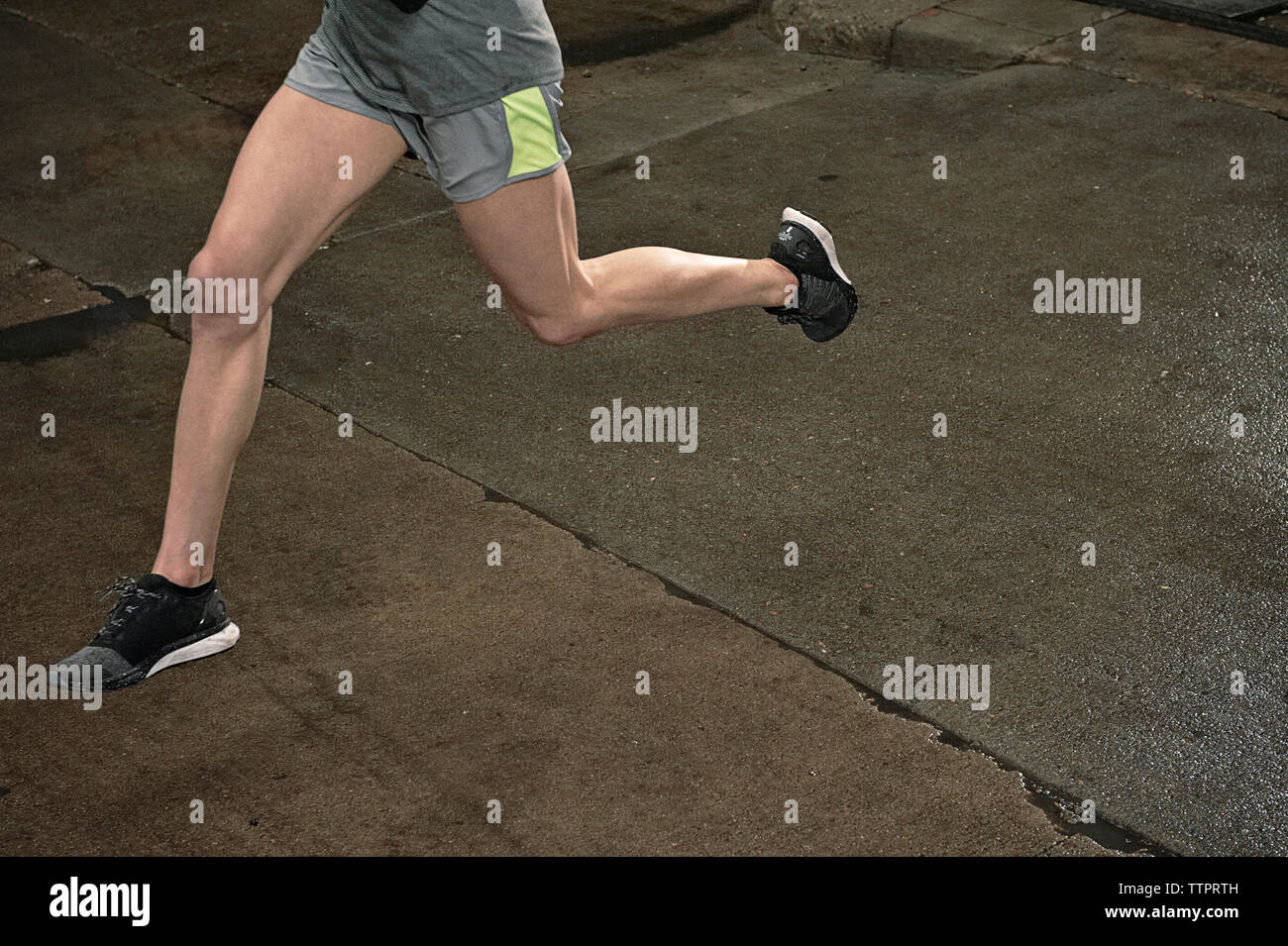 A female runner mid-stride Stock Photo - Alamy