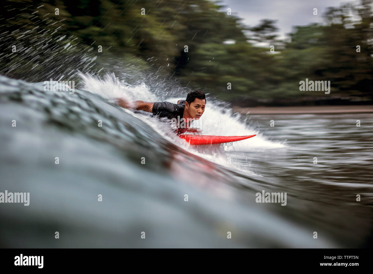Man lying on surfboard in the water hi-res stock photography and images ...