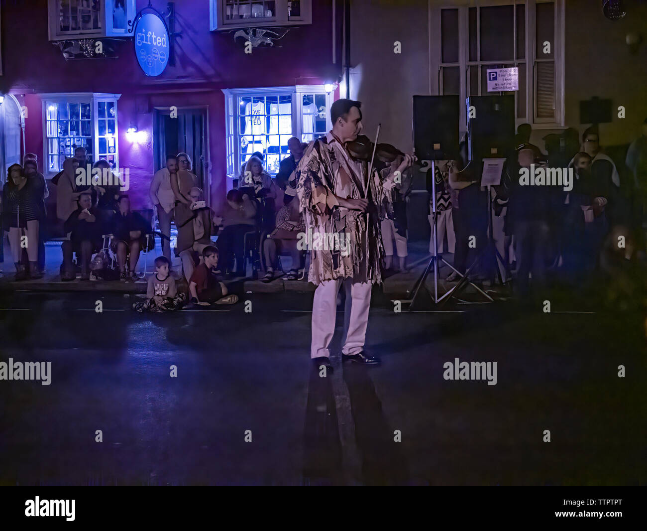 The lights go out and the music of a single violin rings out as a weird ...