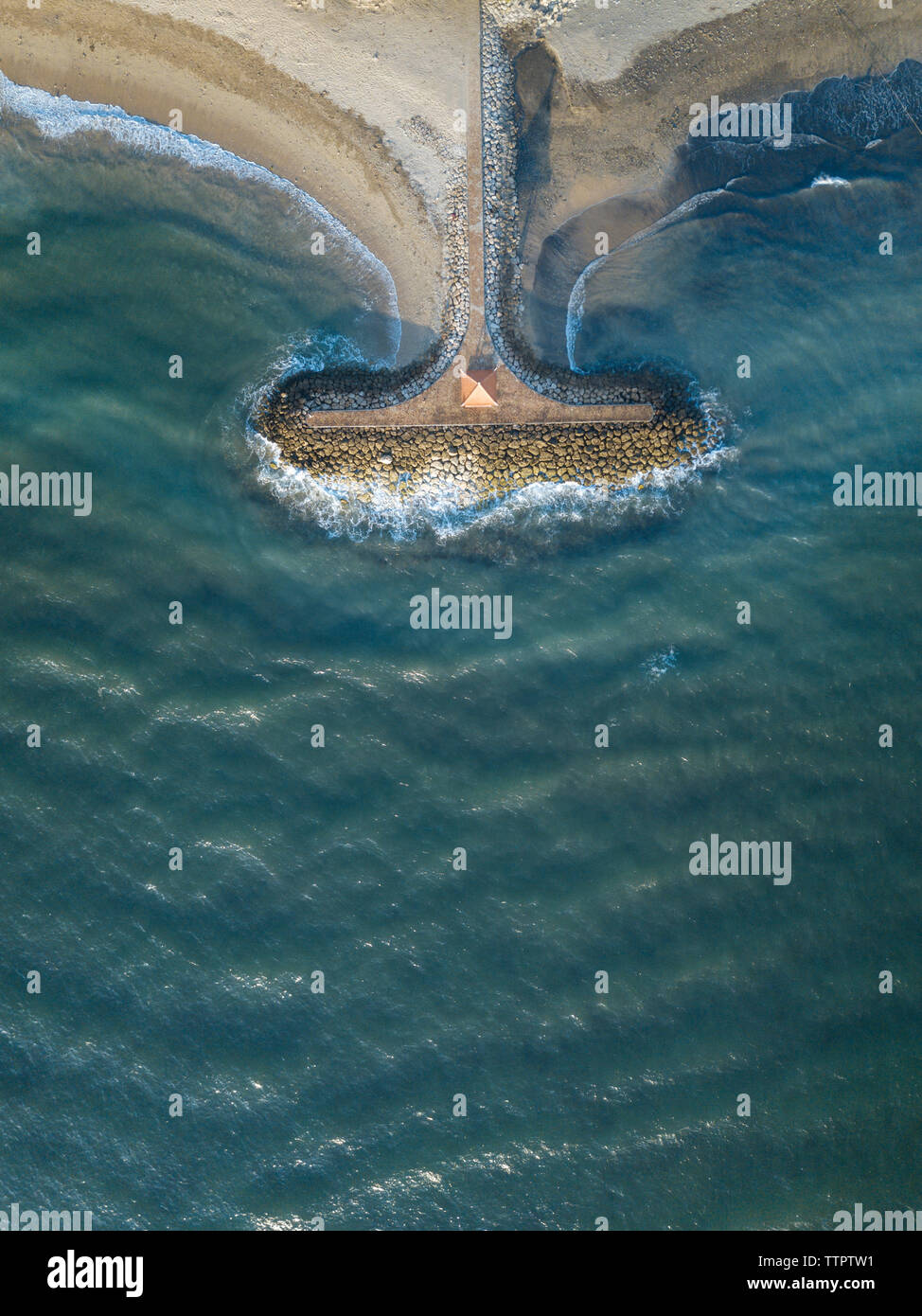 Aerial view of groynes in sea during sunny day Stock Photo - Alamy