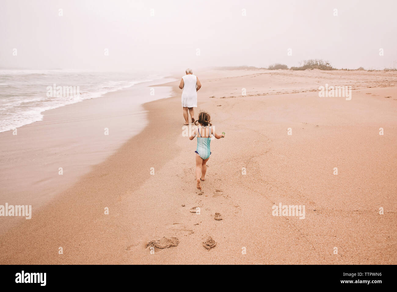 Chasing Great Grandma on thebeach Stock Photo - Alamy