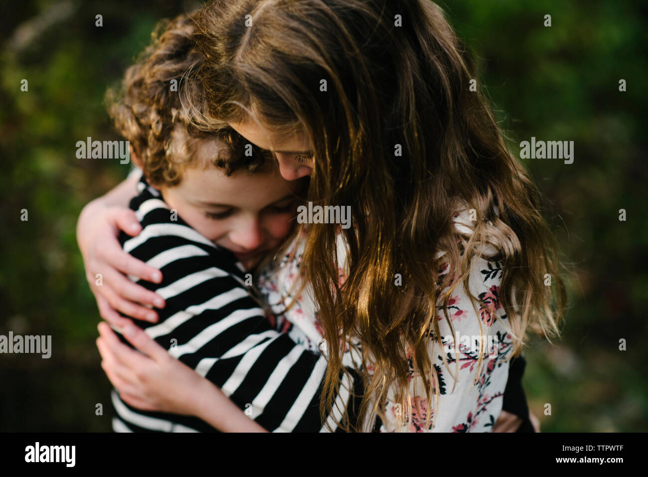 Close-up of loving siblings embracing at park Stock Photo - Alamy