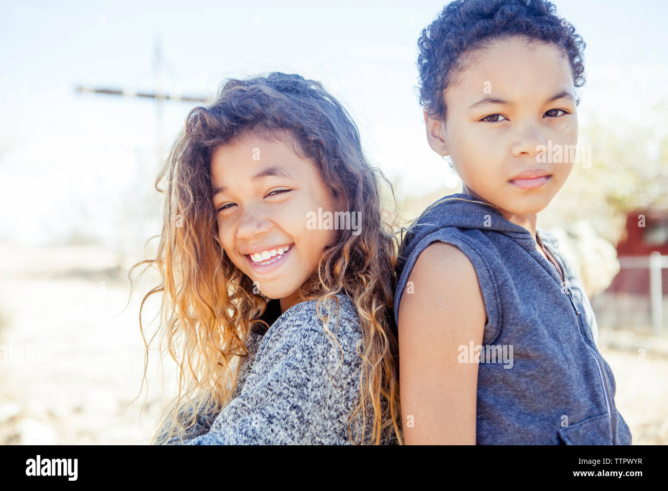 Two girls standing back to back hi-res stock photography and images - Alamy