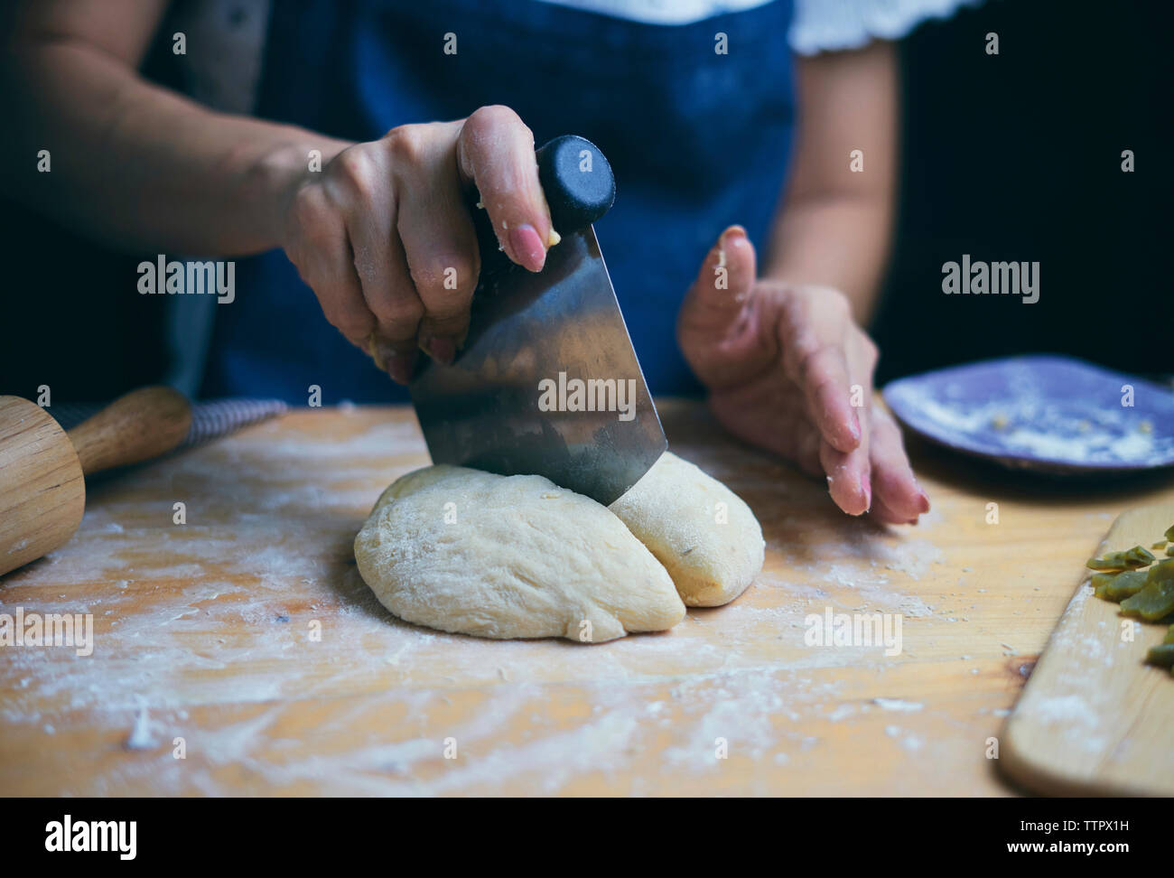 Woman cutting homemade bread hi-res stock photography and images - Alamy